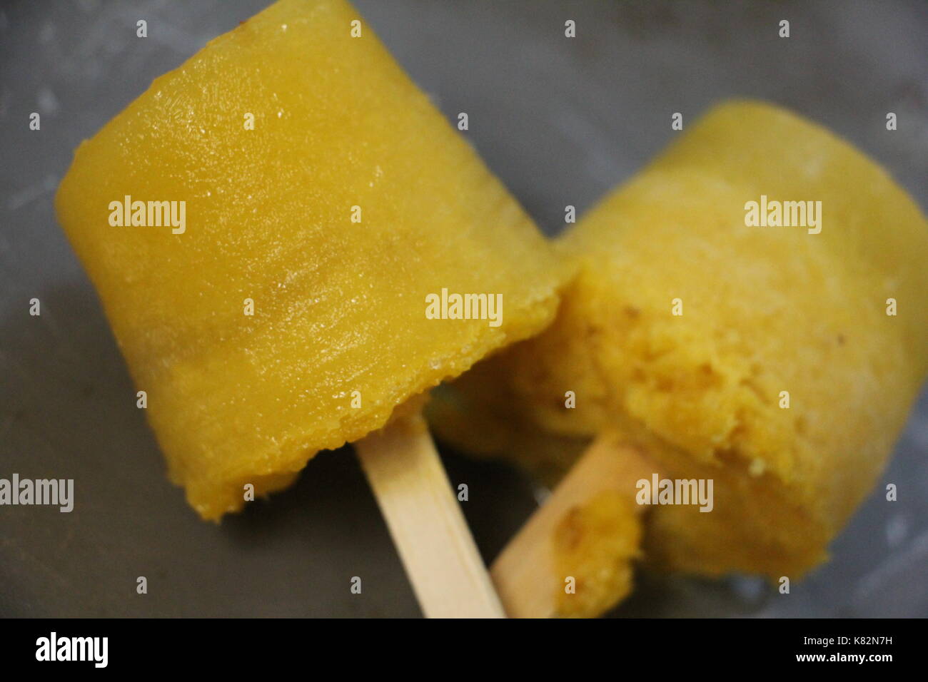 Homemade yellow popsicles Stock Photo - Alamy