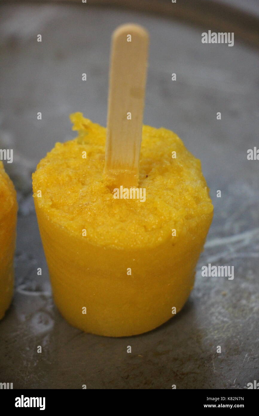 Homemade yellow popsicles Stock Photo - Alamy