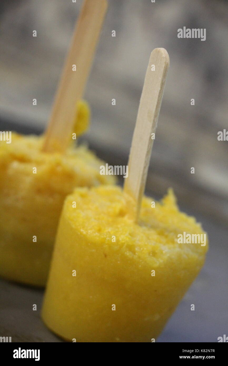 Homemade yellow popsicles Stock Photo - Alamy