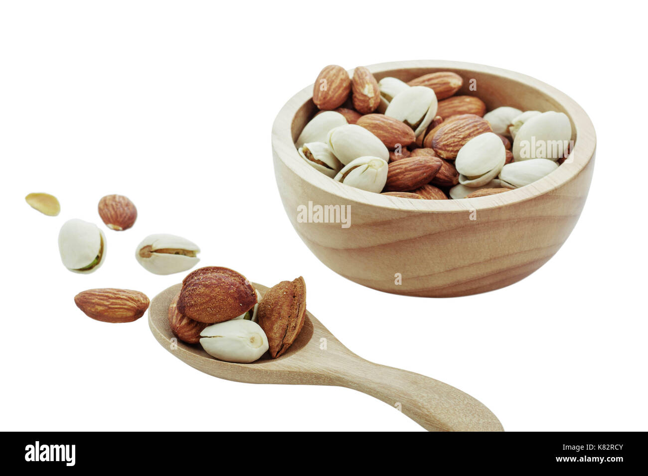 Many almonds on spoon with a white background Stock Photo - Alamy