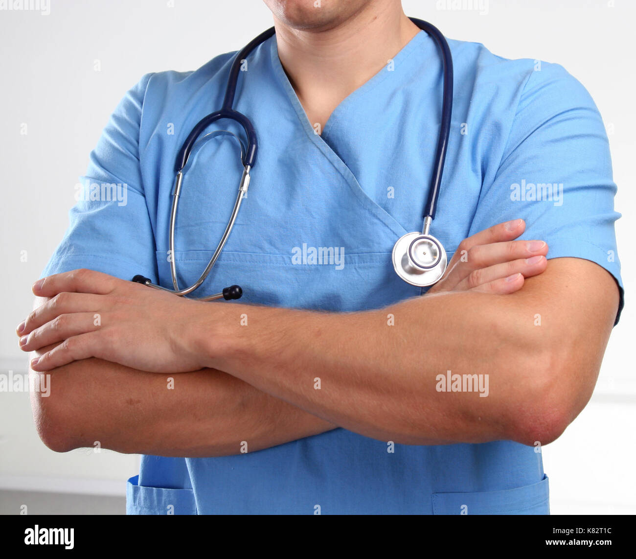 Doctor in blue uniform holding X-rays Stock Photo - Alamy