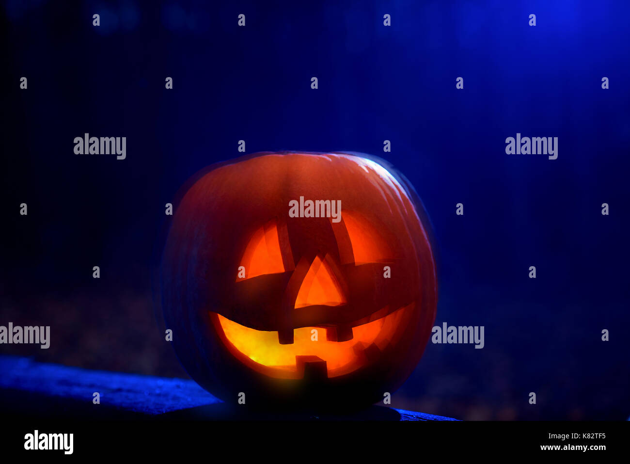 Scary blurry red pumpkin with smoke inside, big eyes, mouth and three ...