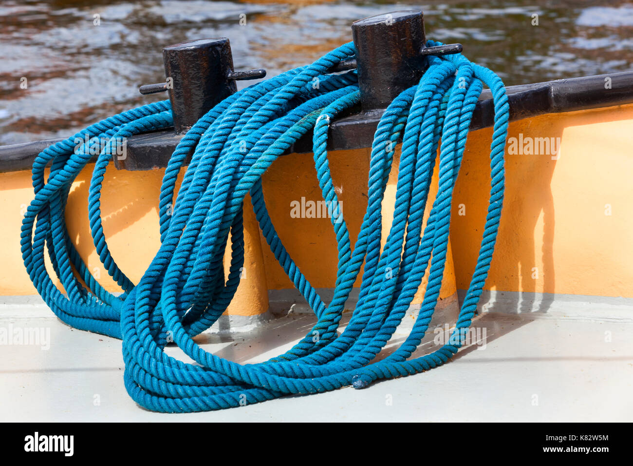 Bollards and a blue rope on a ship Stock Photo - Alamy