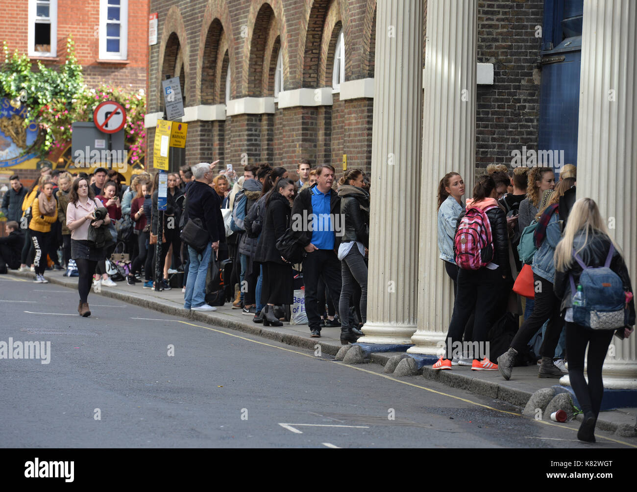 People queue outside Theatre Royal Drury Lane in London as auditions ...