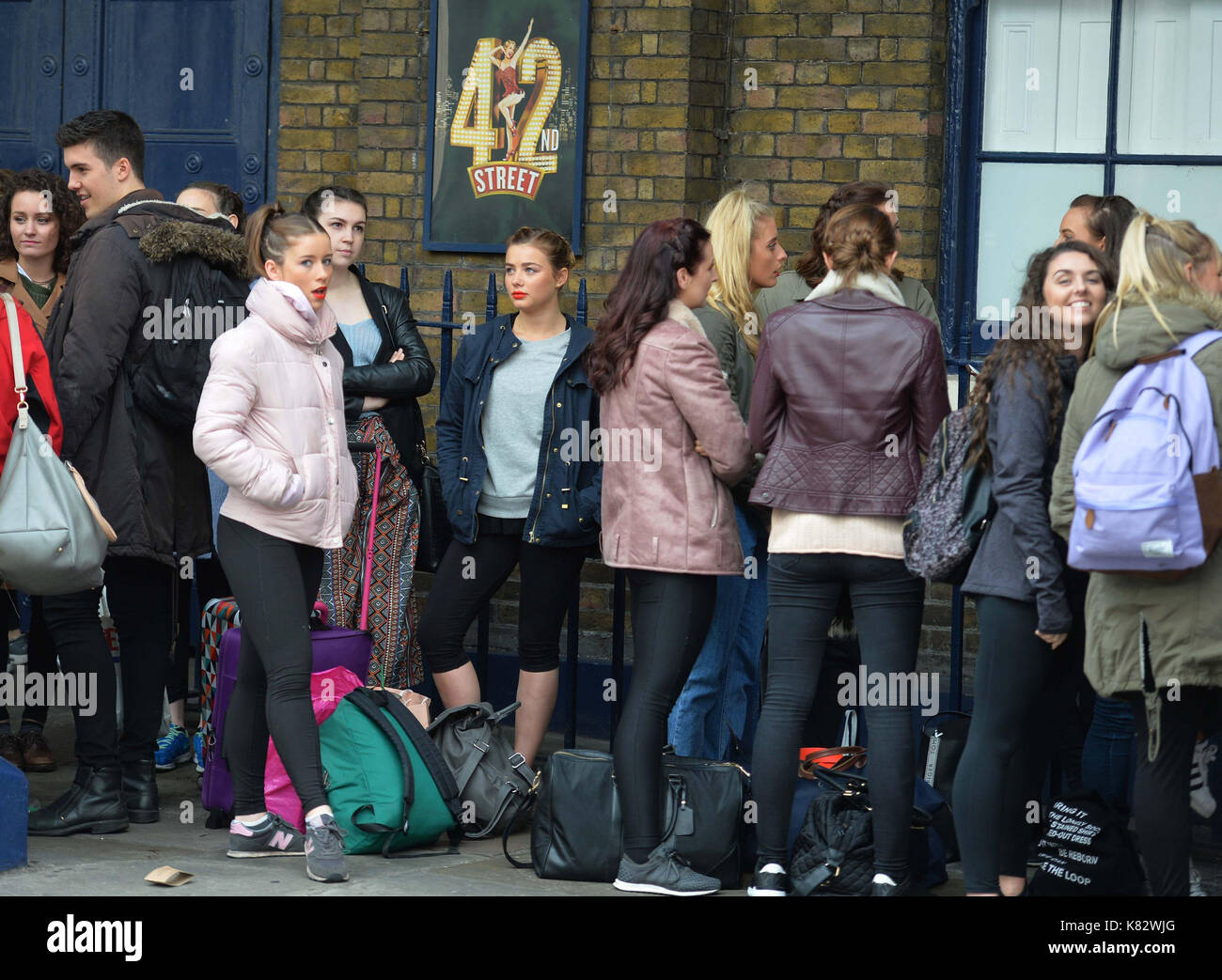 People queue outside Theatre Royal Drury Lane in London as auditions ...