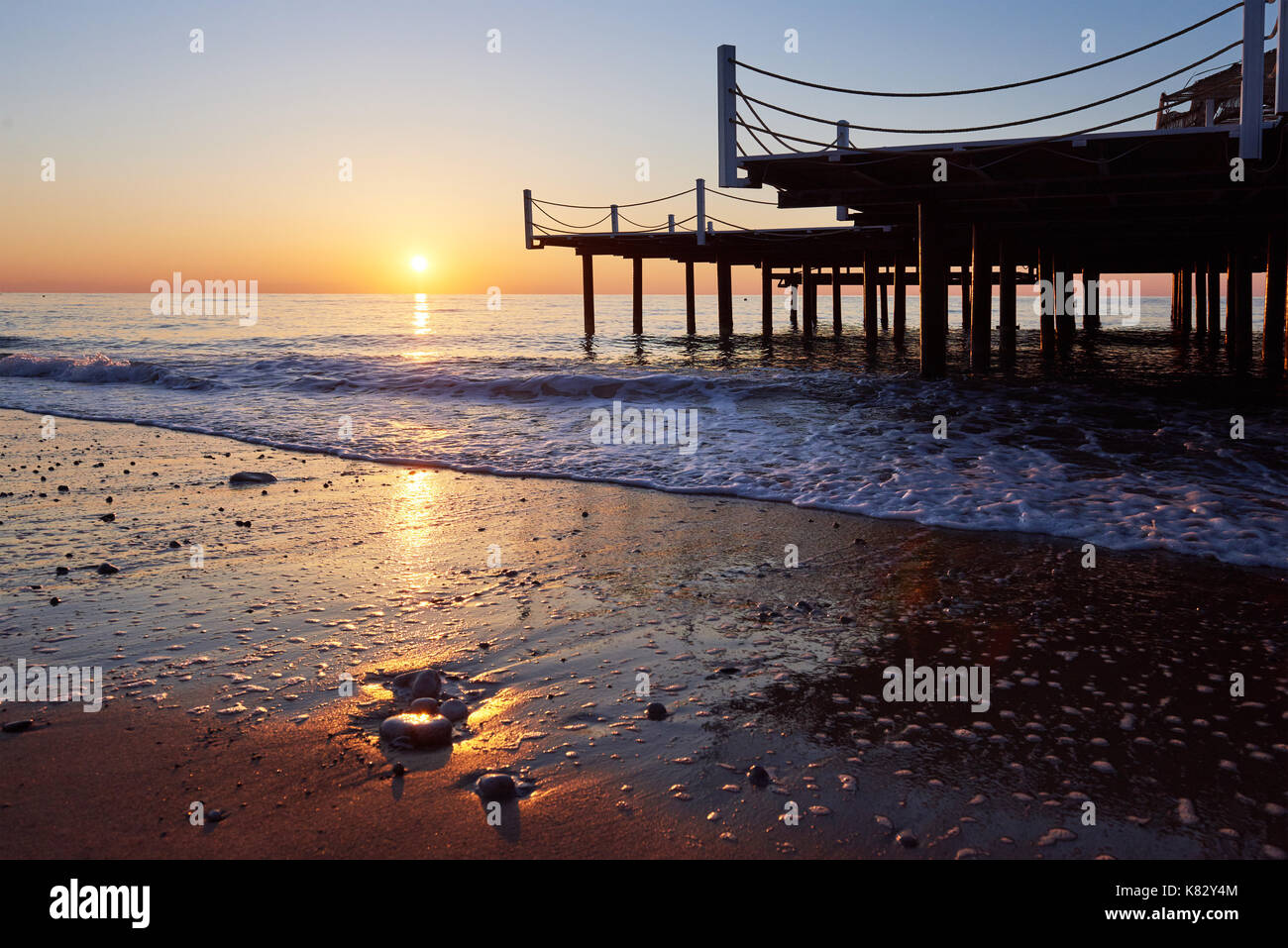 Wooden pier on a fancy orange sunset Stock Photo - Alamy