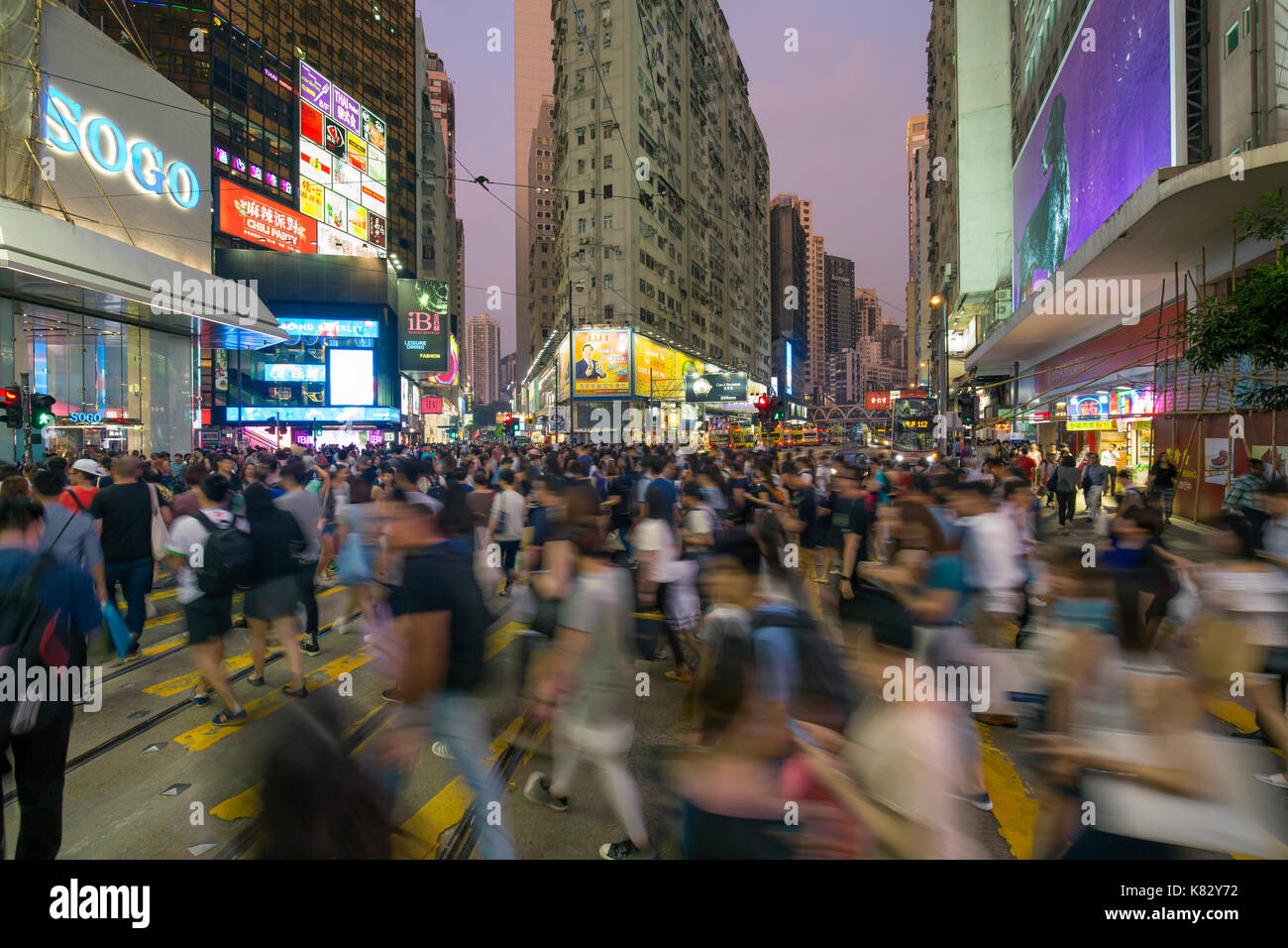 Pedestrians and traffic at a busy road crossing in Causeway Bay, Hong ...