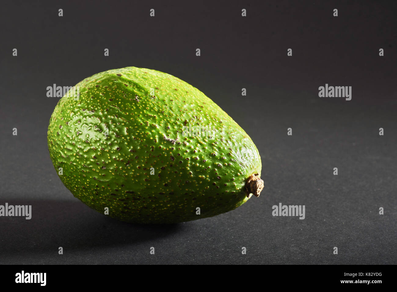Fresh delicious avocado isolated on a black background Stock Photo - Alamy