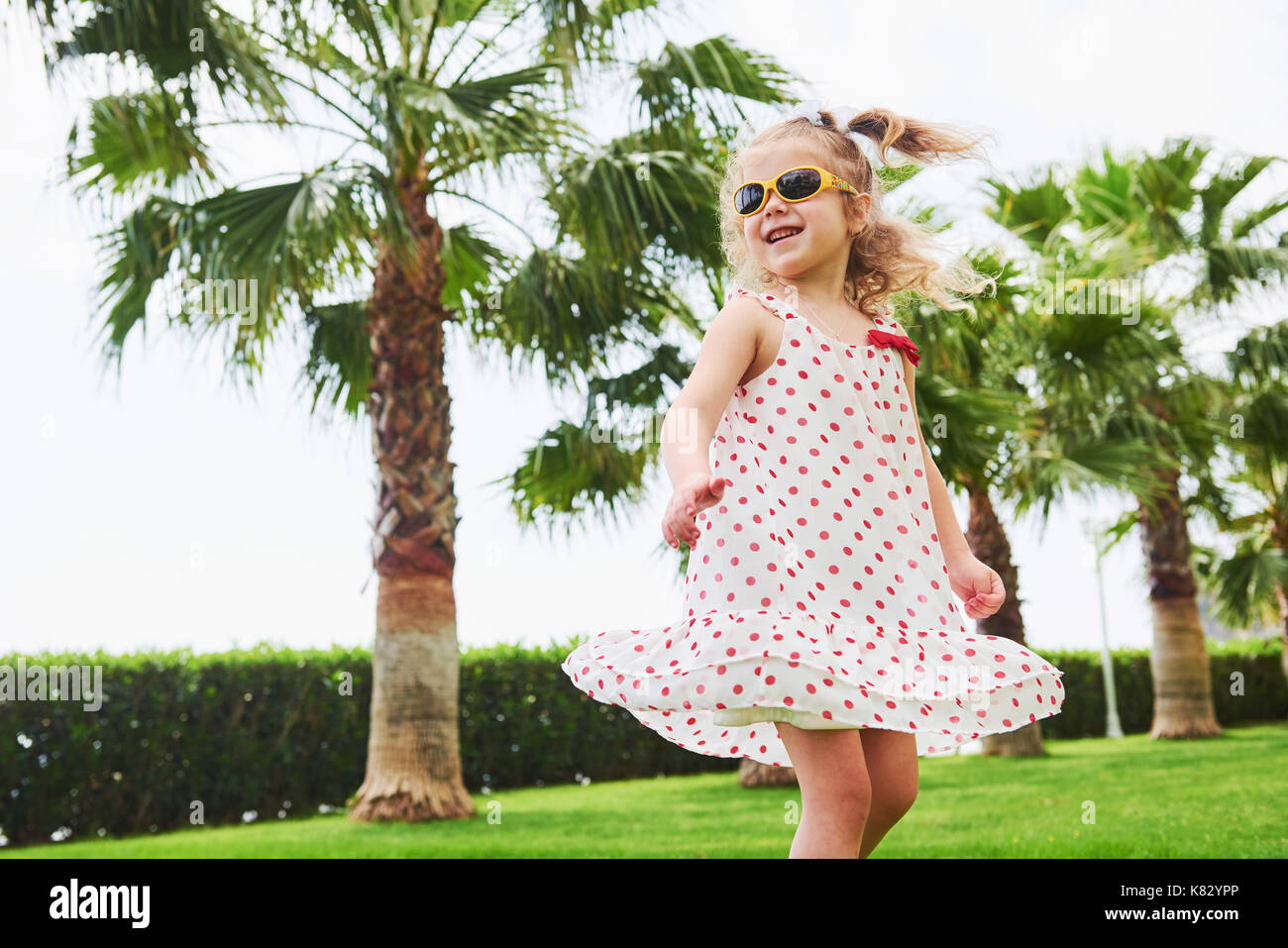baby girl in a park near trees Stock Photo - Alamy