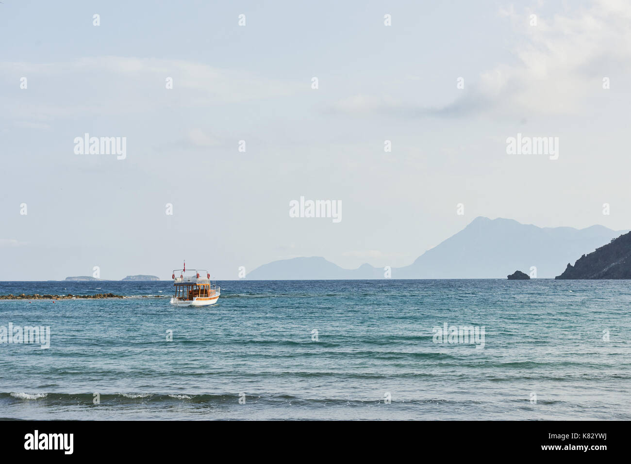 Boats float in the calm blue sea water in Turkey Stock Photo - Alamy