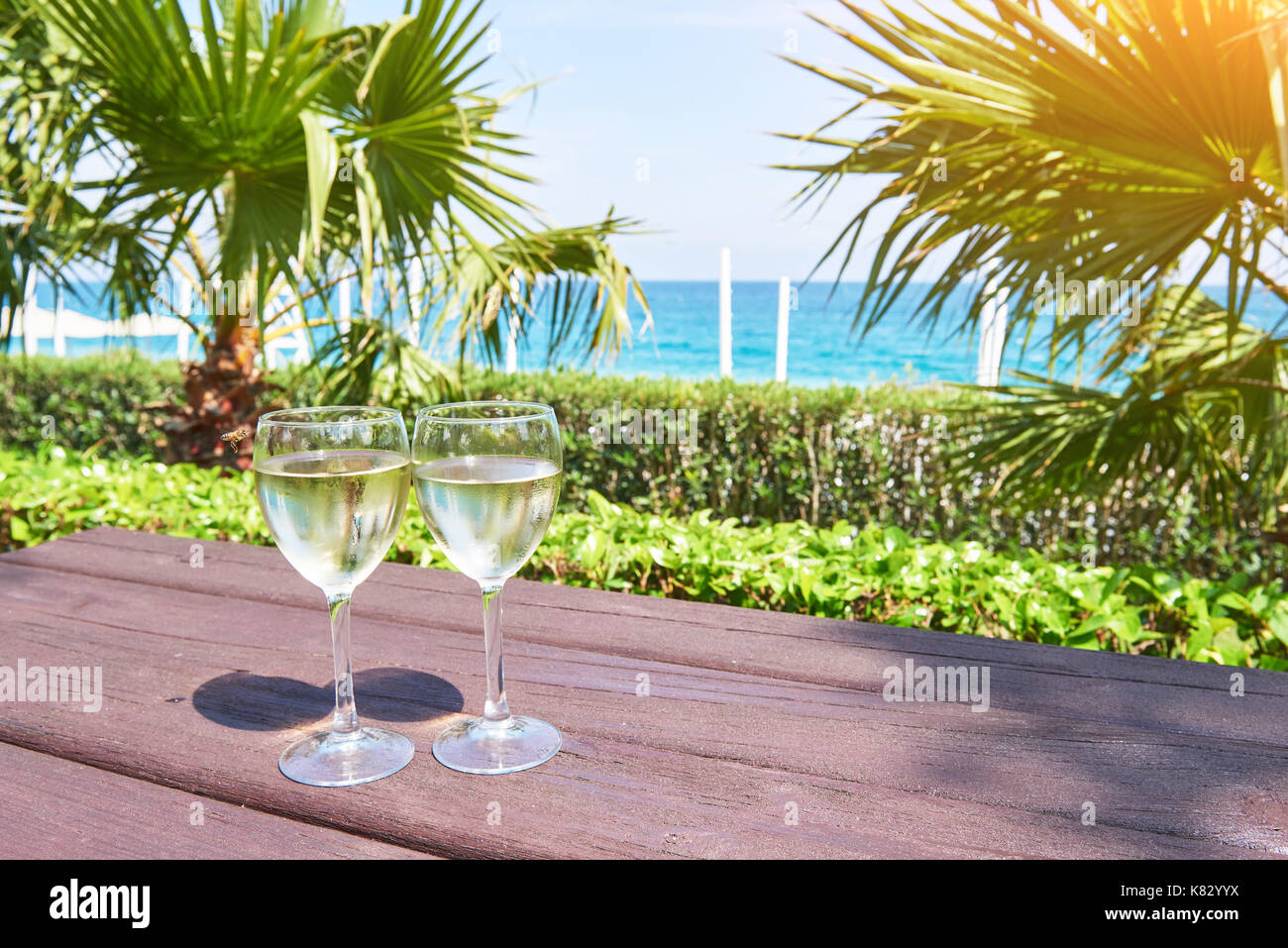 Glasses of champagne at a resort pool in a luxury hotel. Party by the ...