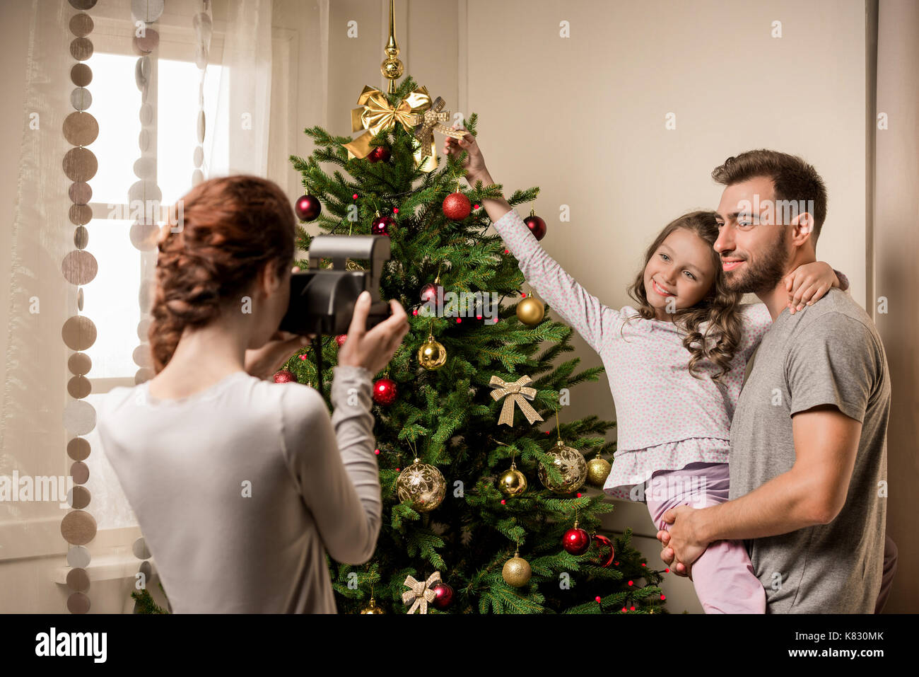 family preparing christmas tree Stock Photo - Alamy