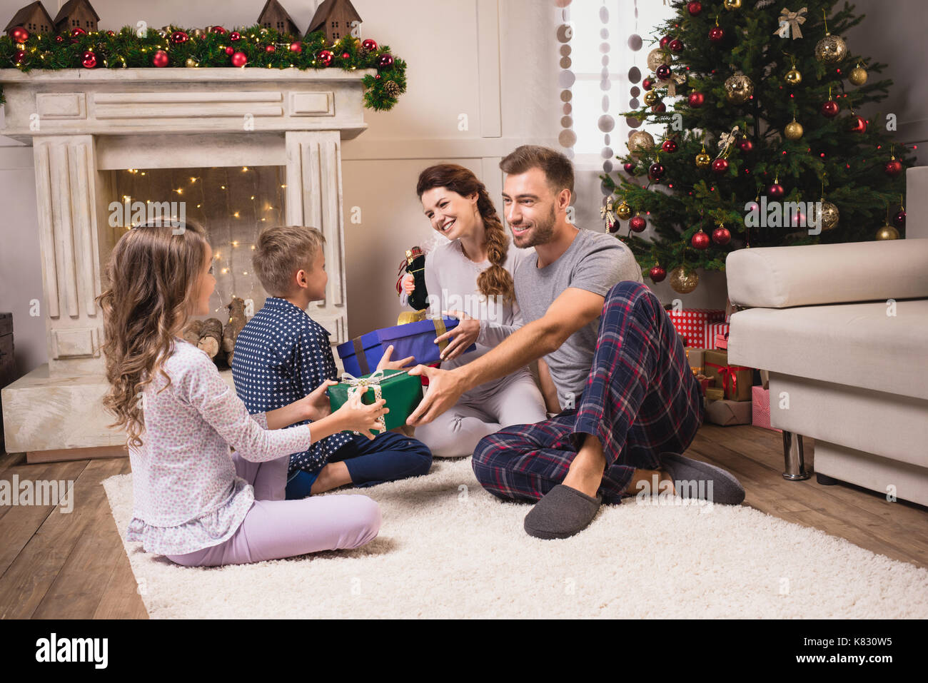 parents and kids on christmas Stock Photo - Alamy