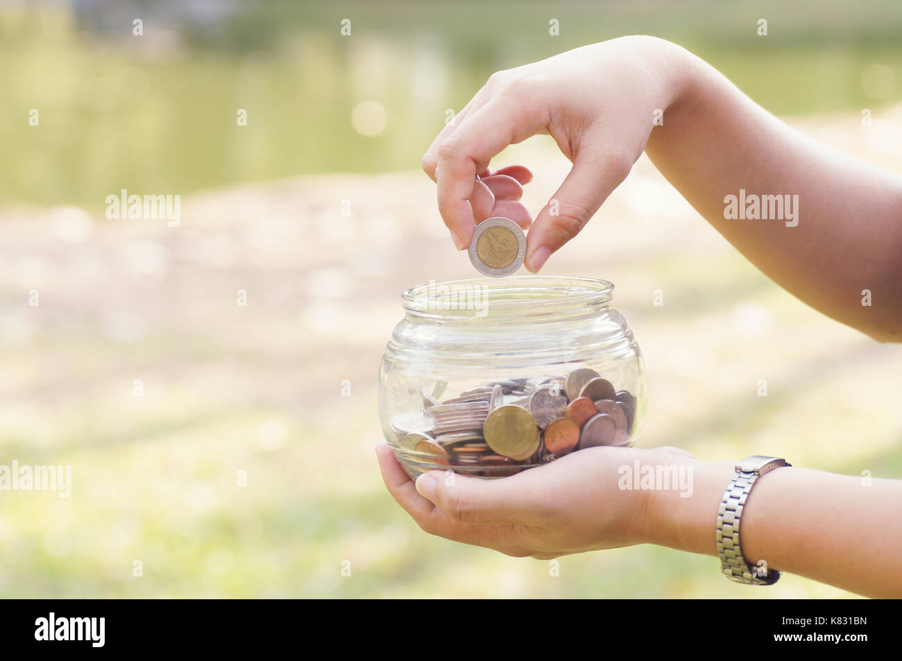 Putting coins hi-res stock photography and images - Alamy