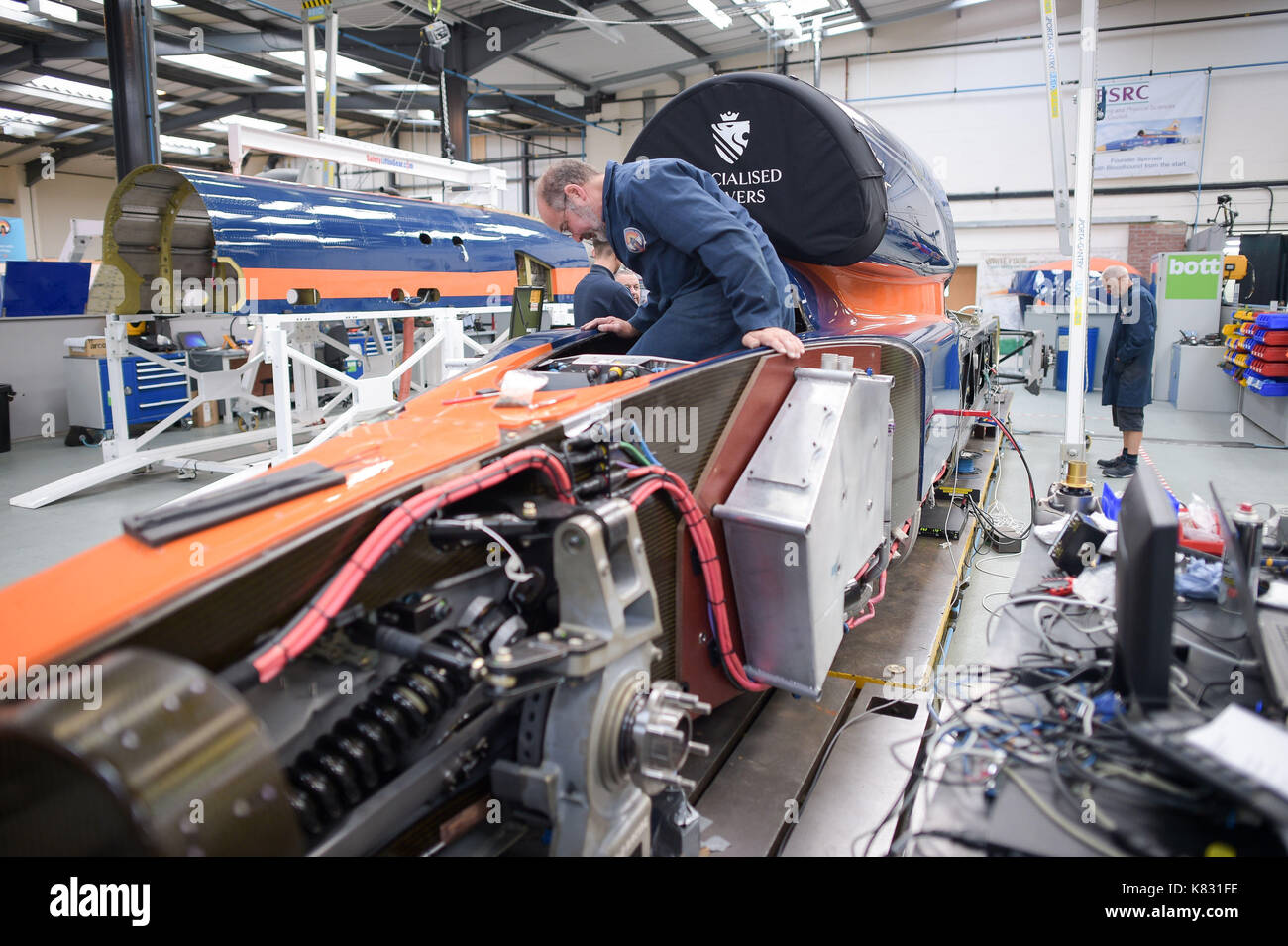 An engineer climbs into the cockpit to fit a footplate, at the ...