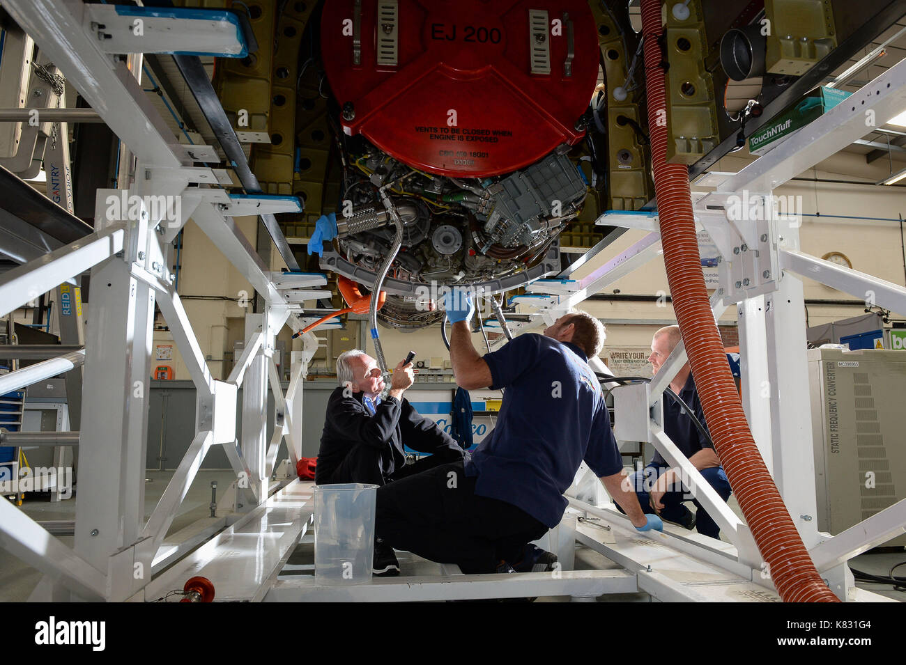 Engineers work on the upper chassis, which houses the jet engine, in ...