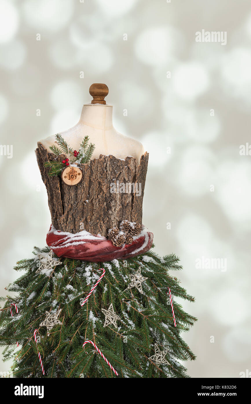 Mannequin dressed for Christmas with pine branches Stock Photo - Alamy