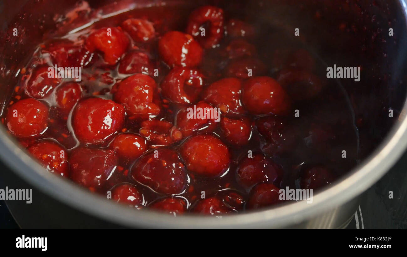 Cherry in syrup, boiled cherry. Boiling raspberry syrup. Preparation of ...