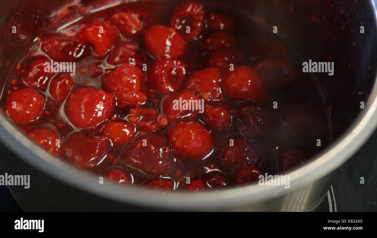 Cherry in syrup, boiled cherry. Boiling raspberry syrup. Preparation of ...