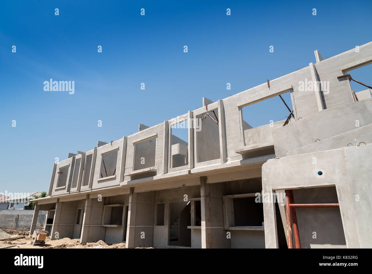 Row of Townhouse prefabricated building isolated on blue sky background ...