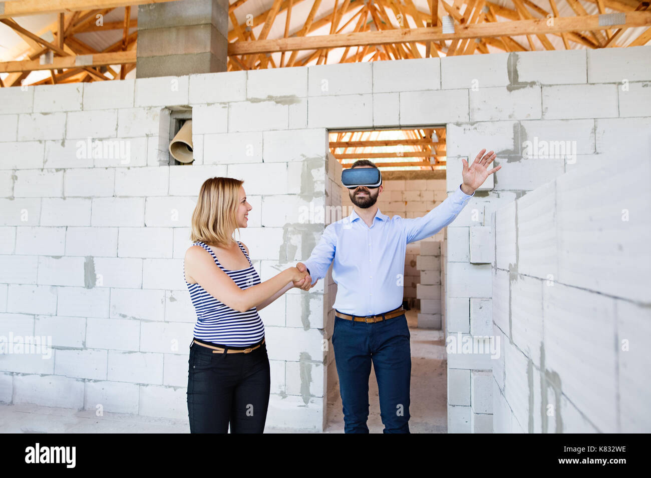 Young married couple at the construction site Stock Photo - Alamy