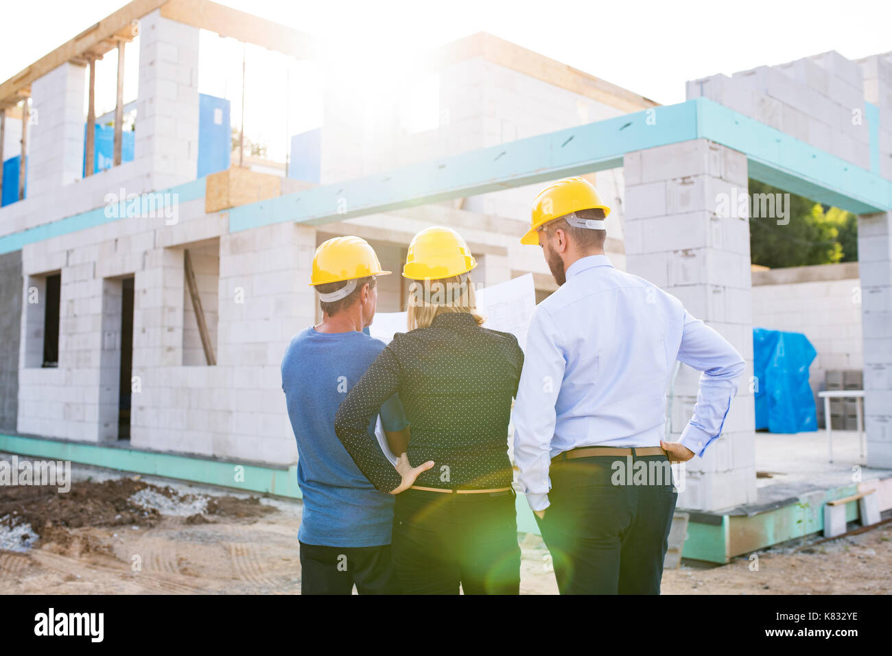 Architects and worker at the construction site Stock Photo - Alamy