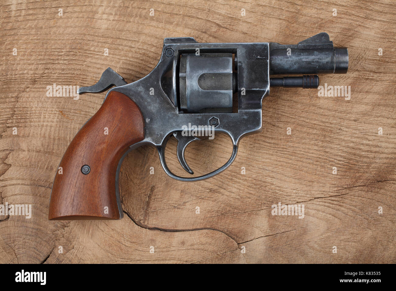 Revolver on the wooden table Stock Photo - Alamy