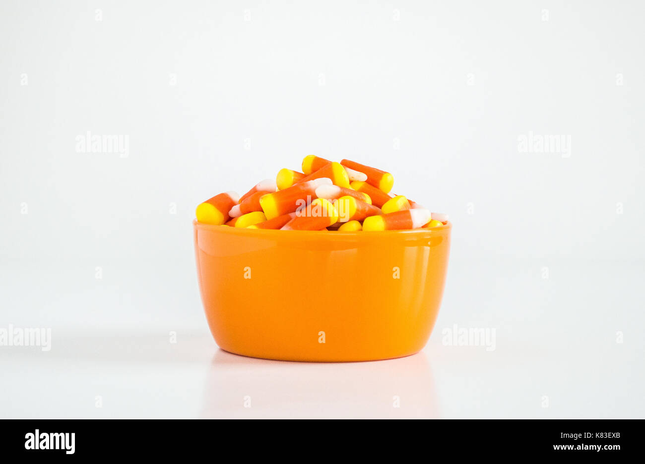 candy corn in an orange bowl isolated on white Stock Photo - Alamy