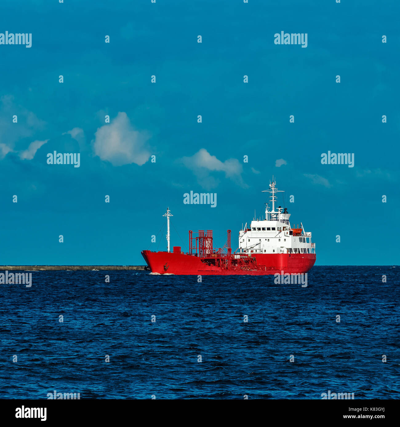 Red cargo tanker ship moving by the river Stock Photo - Alamy