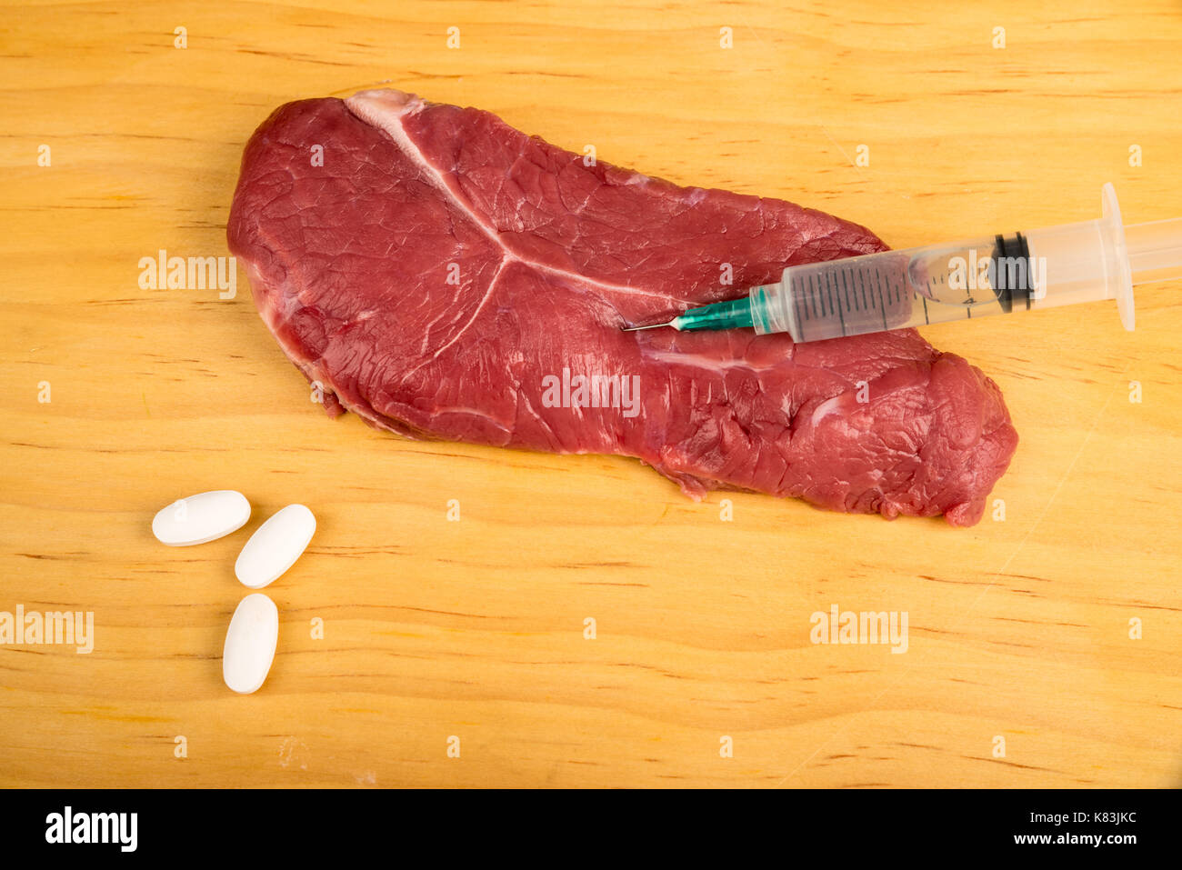 Hormones being injected in a beef steak, a conceptual food manipulation ...