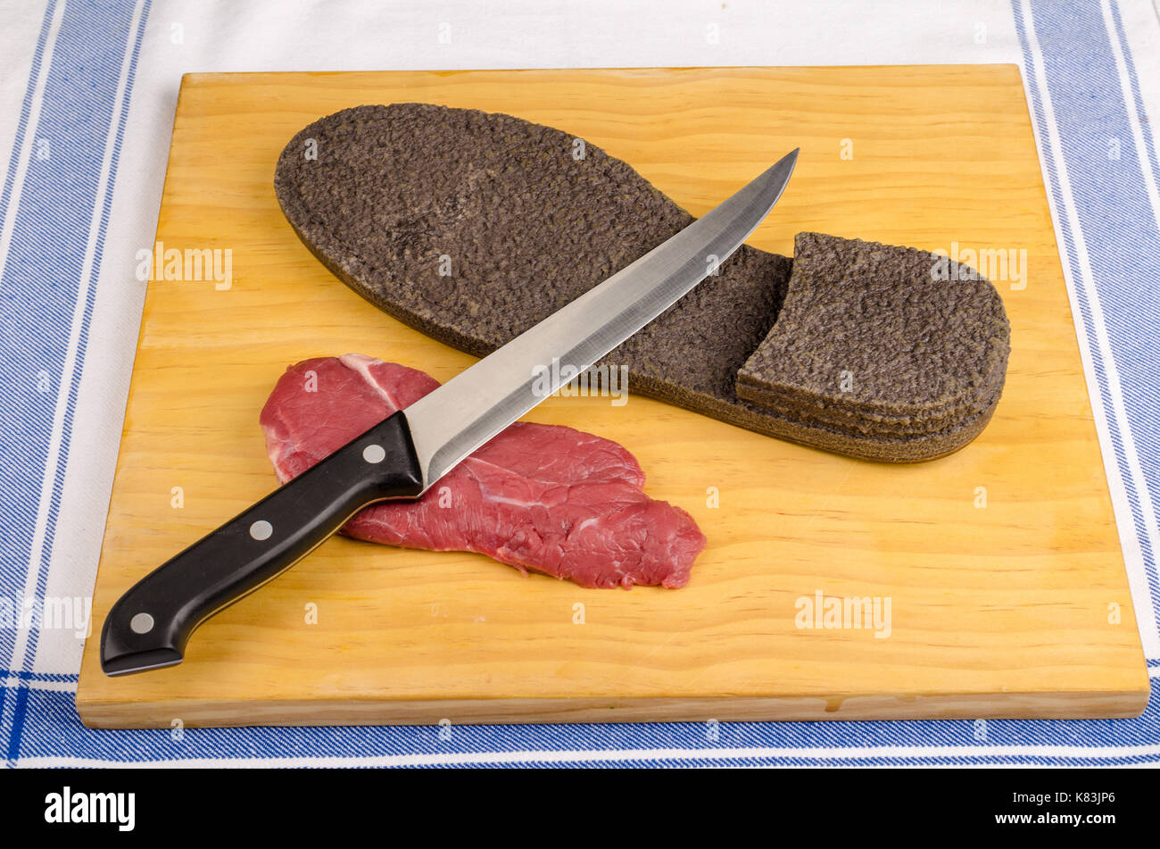 Beef steak next to a shoe sole, a poor quality meat concept Stock Photo ...