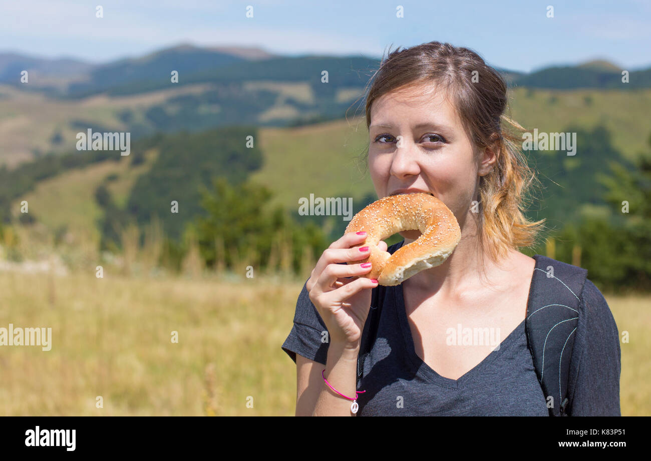 Woman eating a doughnut hi-res stock photography and images - Alamy