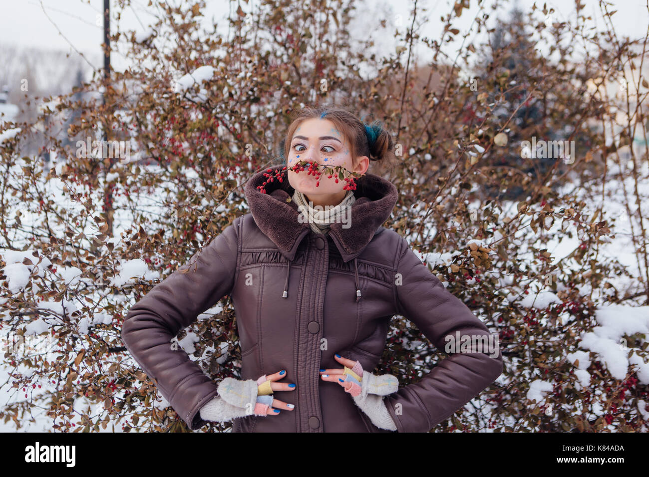 Winter portrait of a girl with bright make up and blue stars on face ...