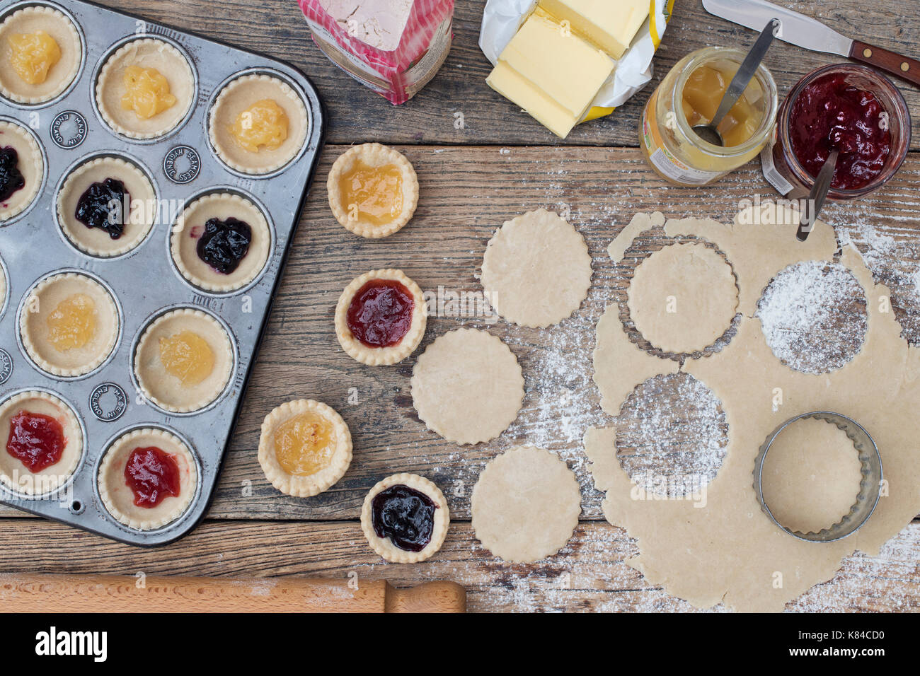 Making and baking homemade jam tarts. Pattern from above Stock Photo ...