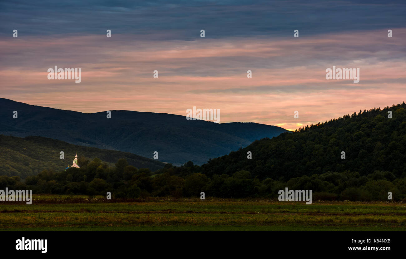church dome over the forest in valley at dawn. mysterious countryside ...