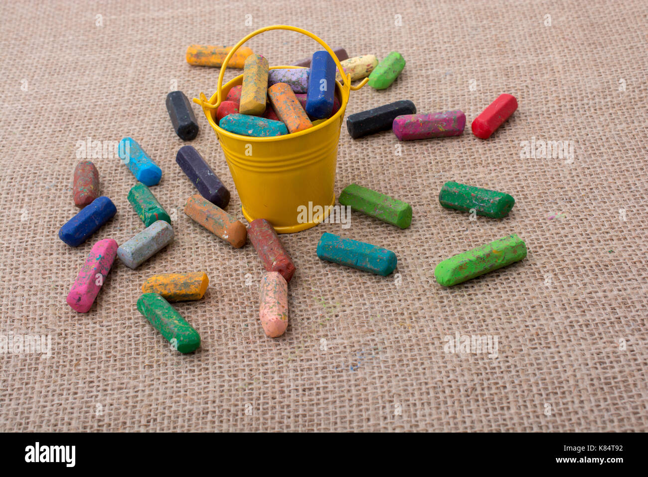 Crayons of various color in a bucket on a canvas Stock Photo - Alamy
