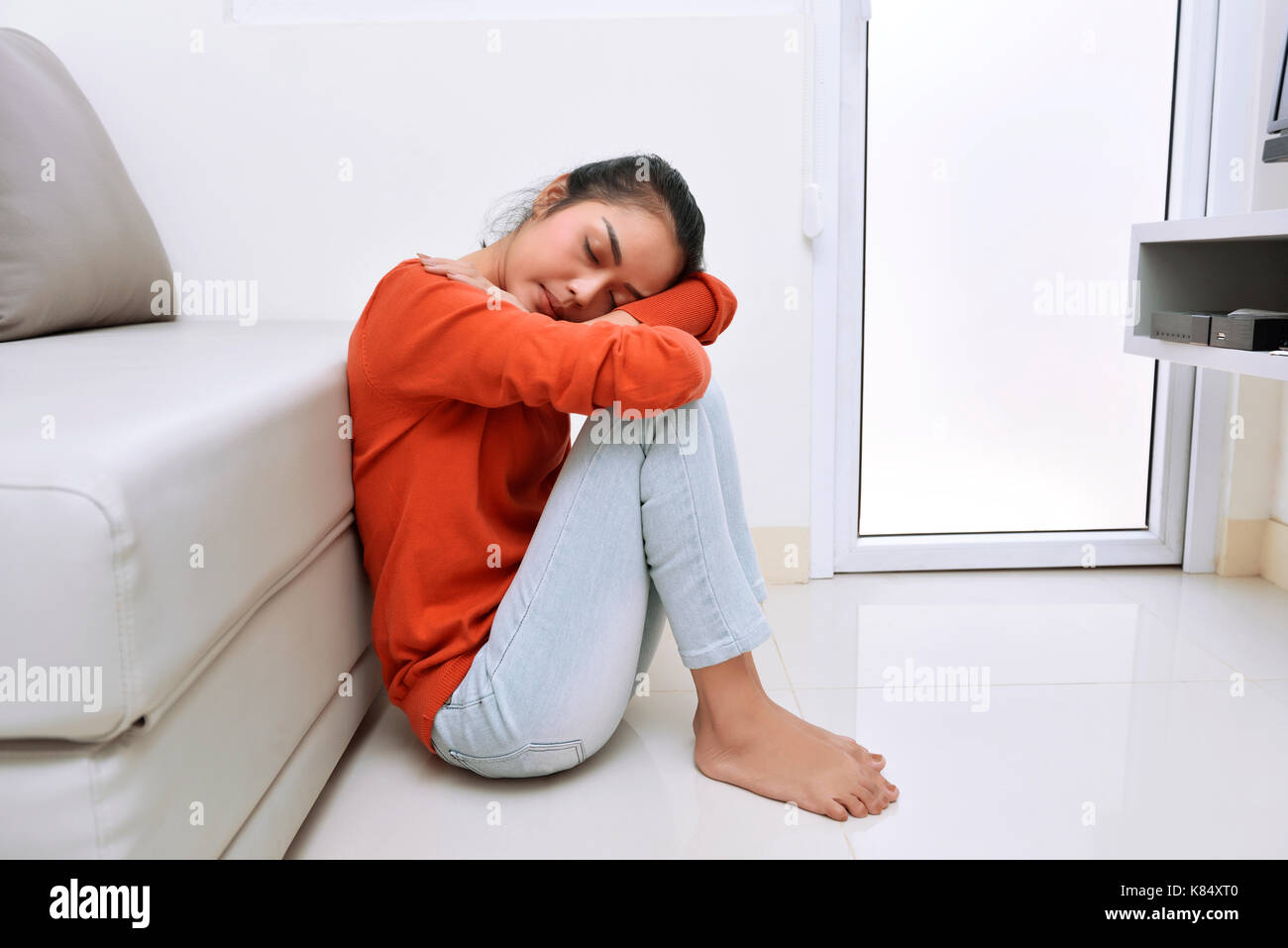 Portrait of tired asian woman sitting and falling asleep on the floor ...