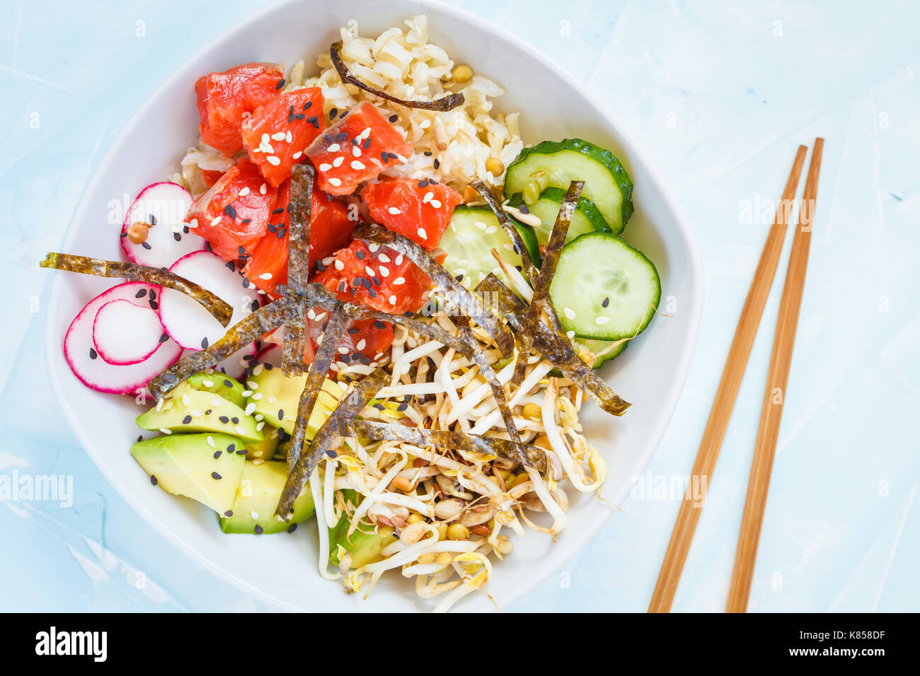 Hawaiian Ahi Poke dish with fish, rice and vegetables Stock Photo - Alamy