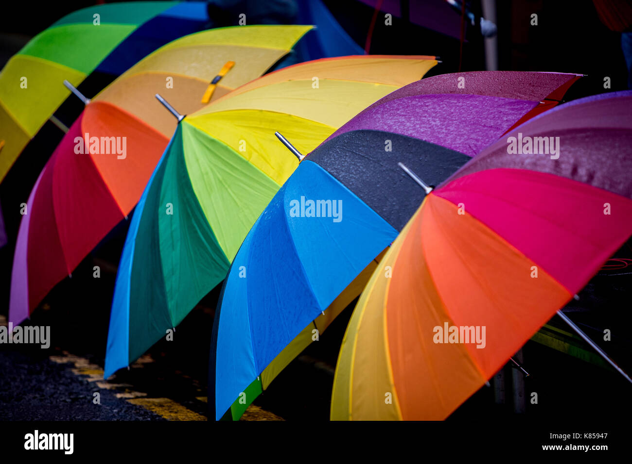 Colourful umbrellas in an line Stock Photo - Alamy