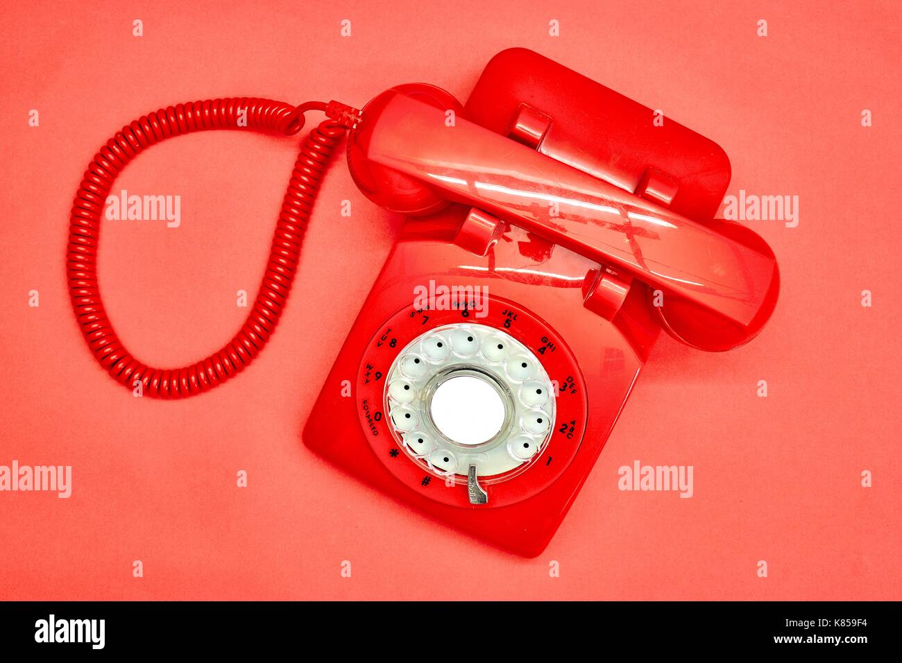 A studio photo of a red rotary telephone Stock Photo - Alamy
