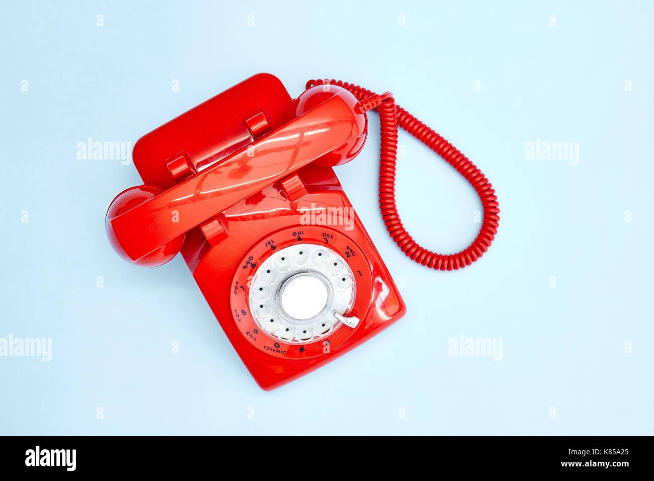 A studio photo of a red rotary telephone Stock Photo - Alamy