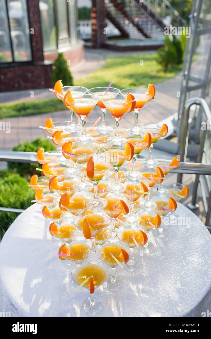 Pyramid from glasses at celebration. Colorful cocktails close up. an ...