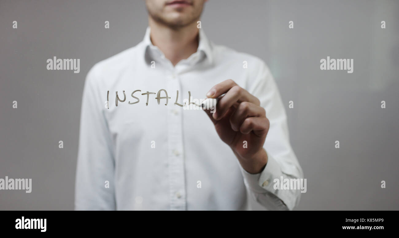 Install, Man Writing on Glass Stock Photo - Alamy