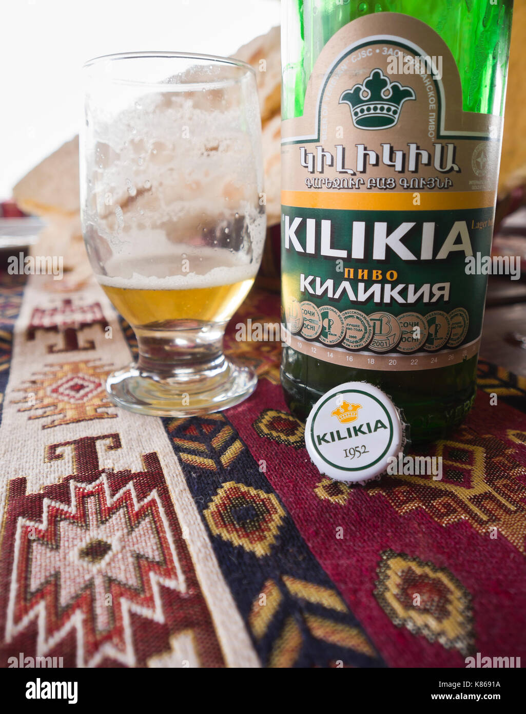 Close up of Armenian Kilikia beer bottle and a near empty glass on a ...
