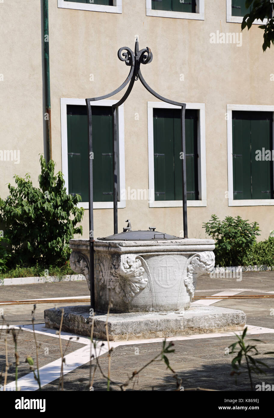 very ancient stone well in a square of a European city Stock Photo - Alamy