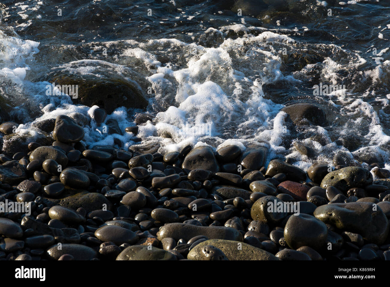 black pebble beach Stock Photo - Alamy