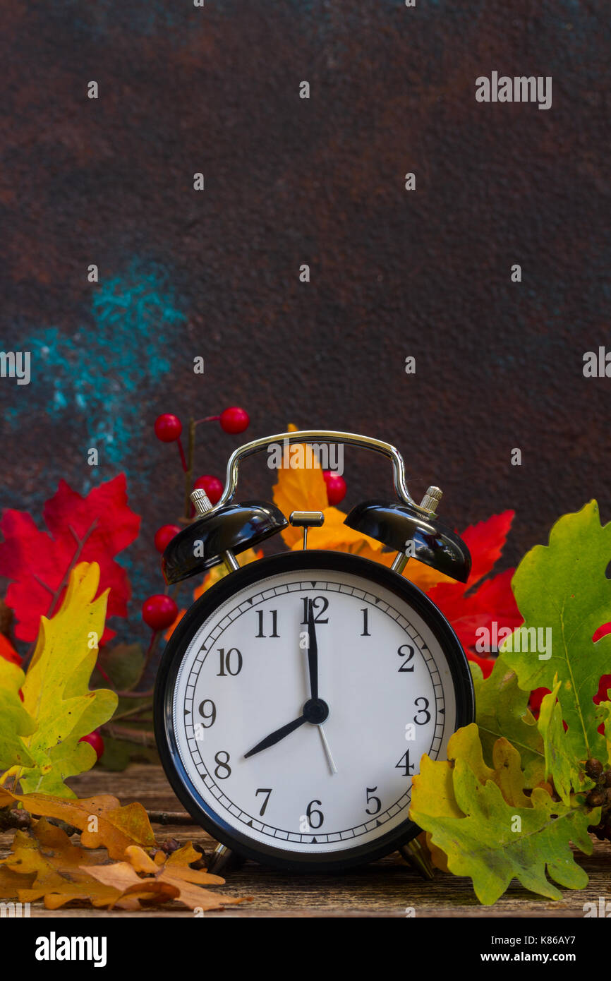 Autumn time - fall leaves with clock Stock Photo - Alamy