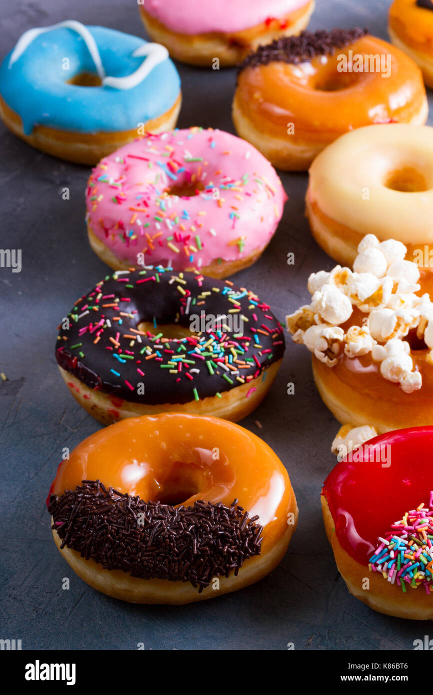 sweet doughnuts on gray stone background Stock Photo - Alamy