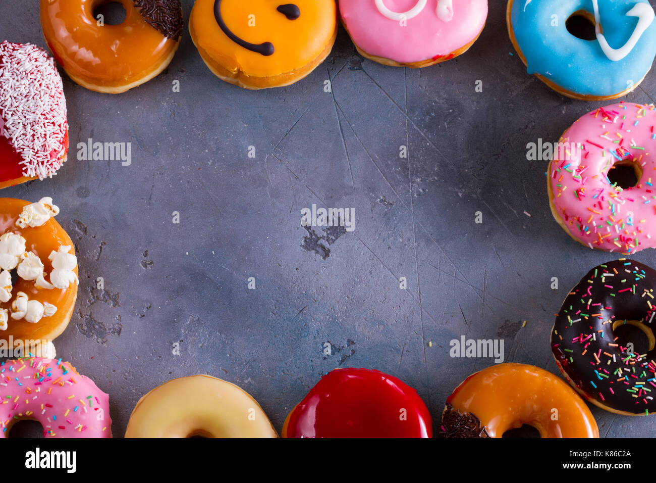sweet doughnuts on gray stone background Stock Photo - Alamy