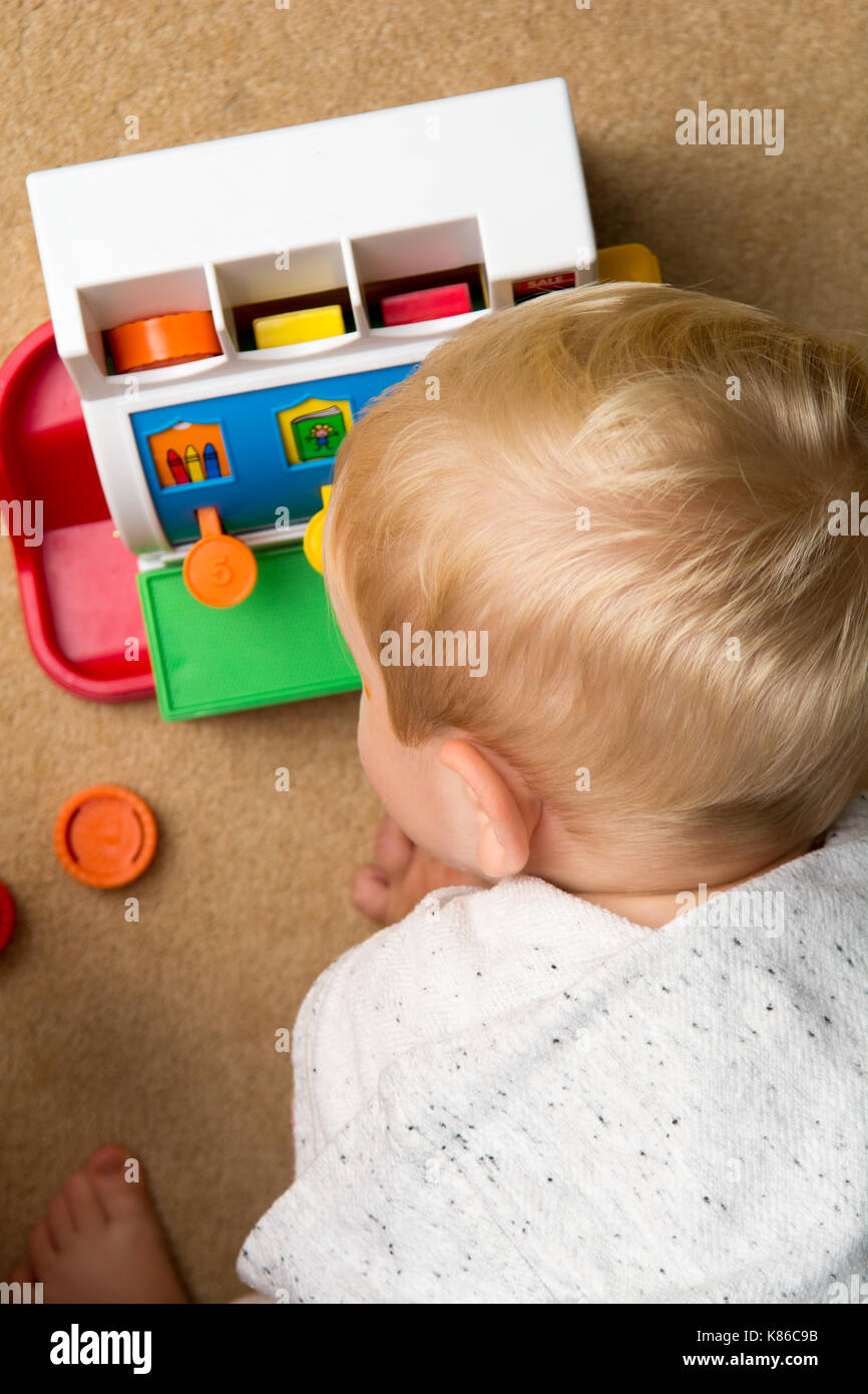 Child learning to count by playing with toy till Stock Photo - Alamy